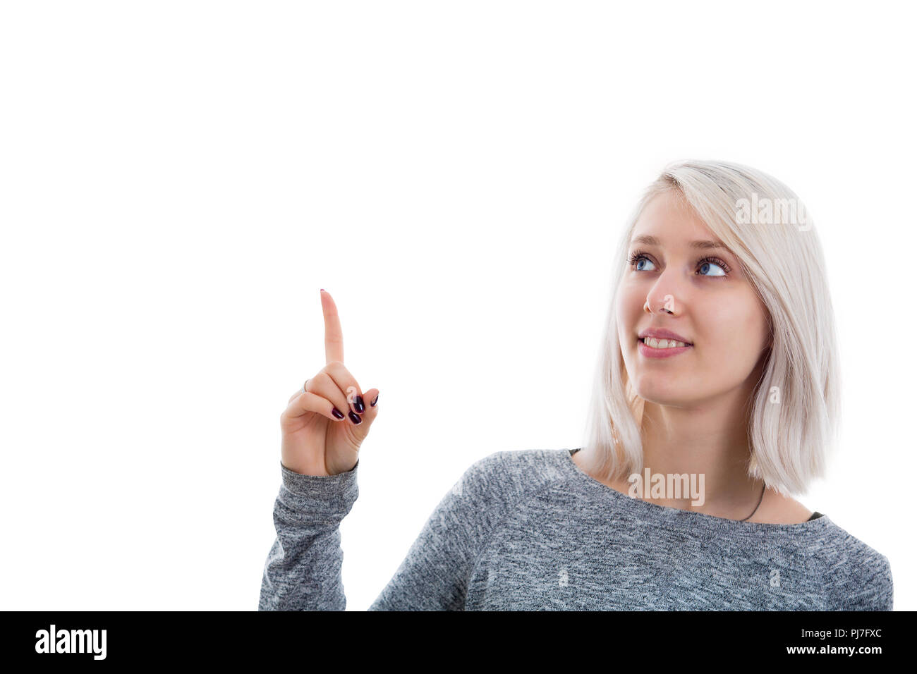 Smiling woman pointing finger up isolated on white background Stock ...
