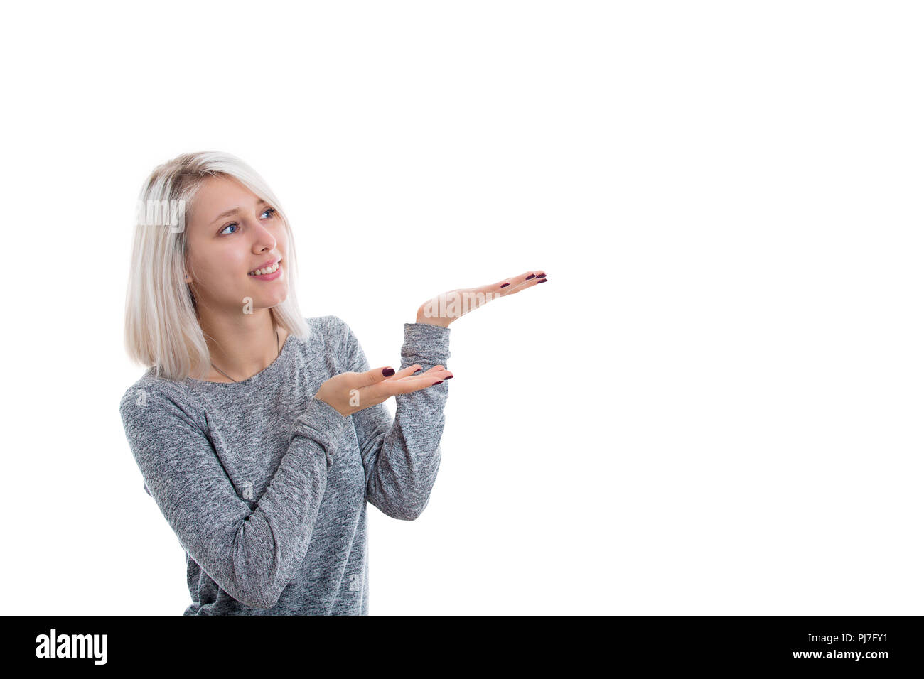 Beautiful girl holding out her hands showing something imaginary ...