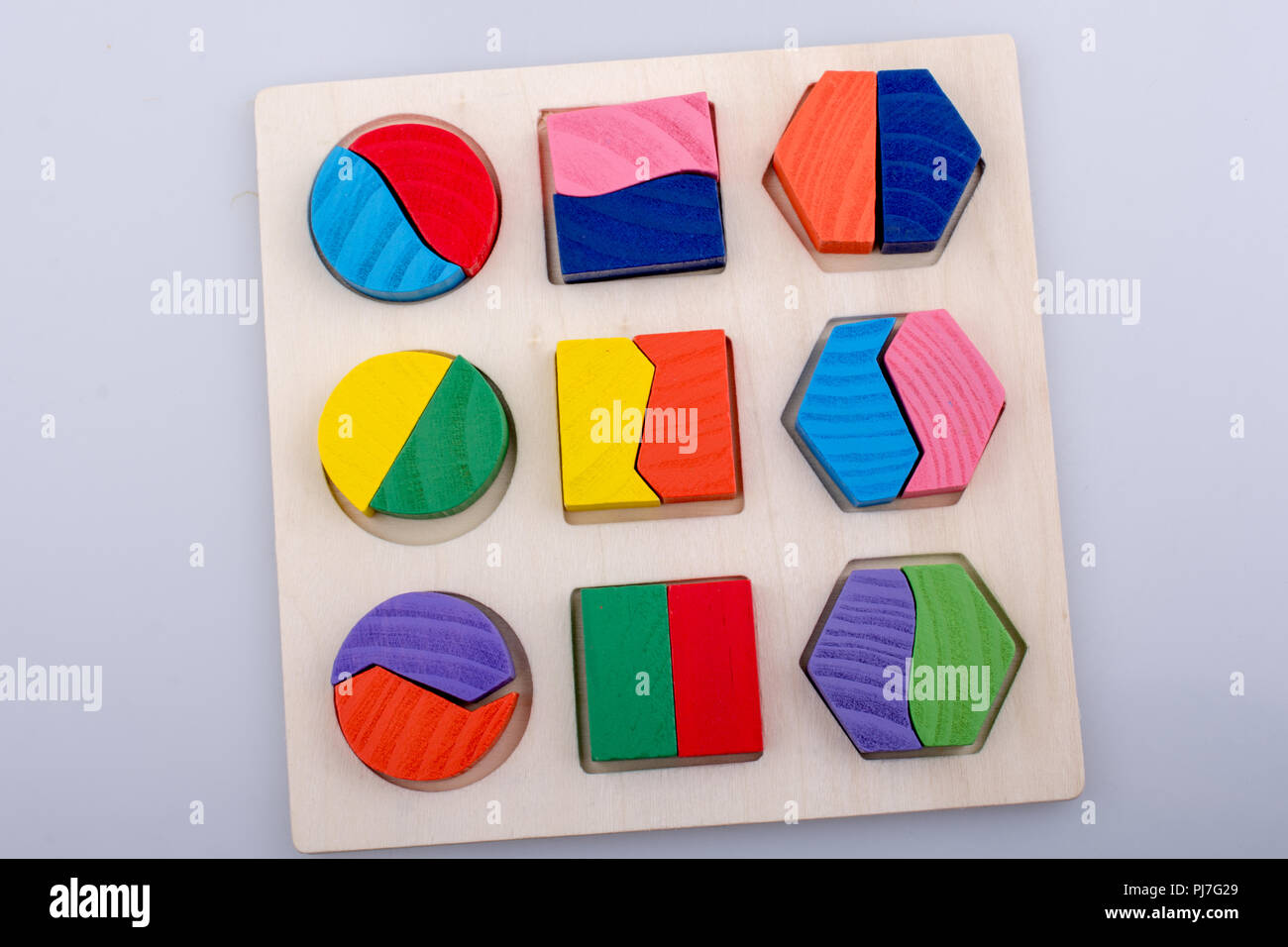 Colorful wooden pieces of a logic puzzle Stock Photo - Alamy