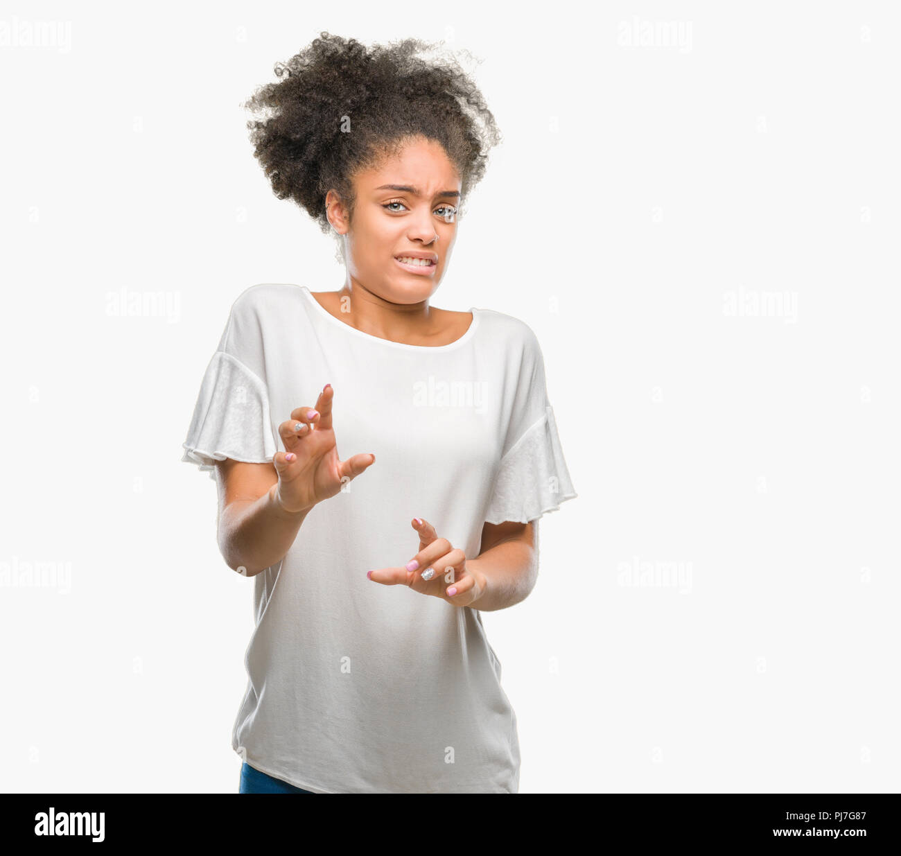 Young afro american woman over isolated background disgusted expression ...