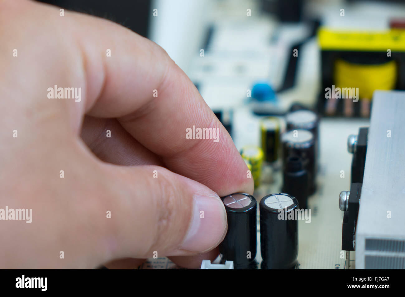 Close up of a man repairing electrical component of a computer Stock ...