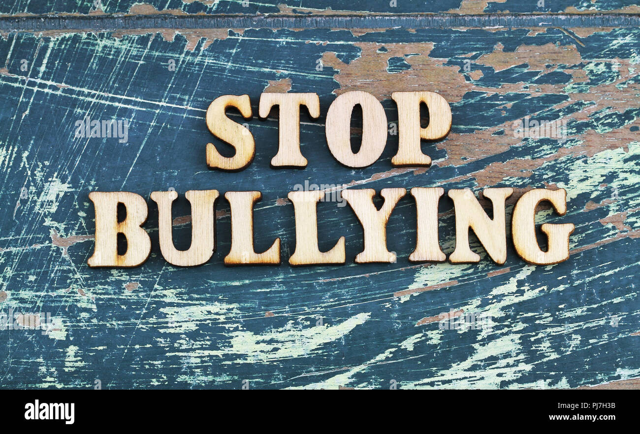 Stop bullying written with wooden letters on rustic wooden surface ...