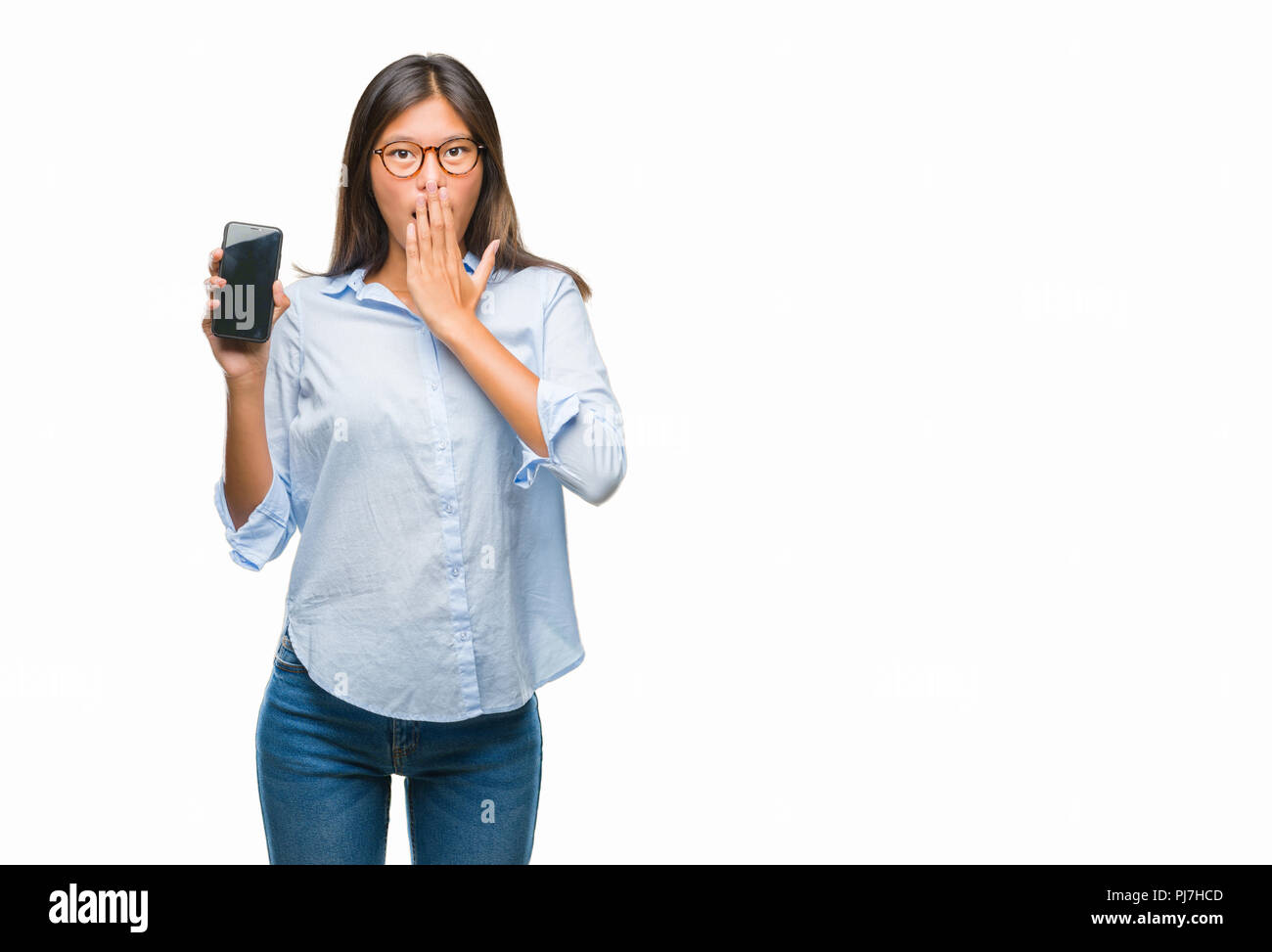Young asian woman showing smartphone blank screen over isolated ...
