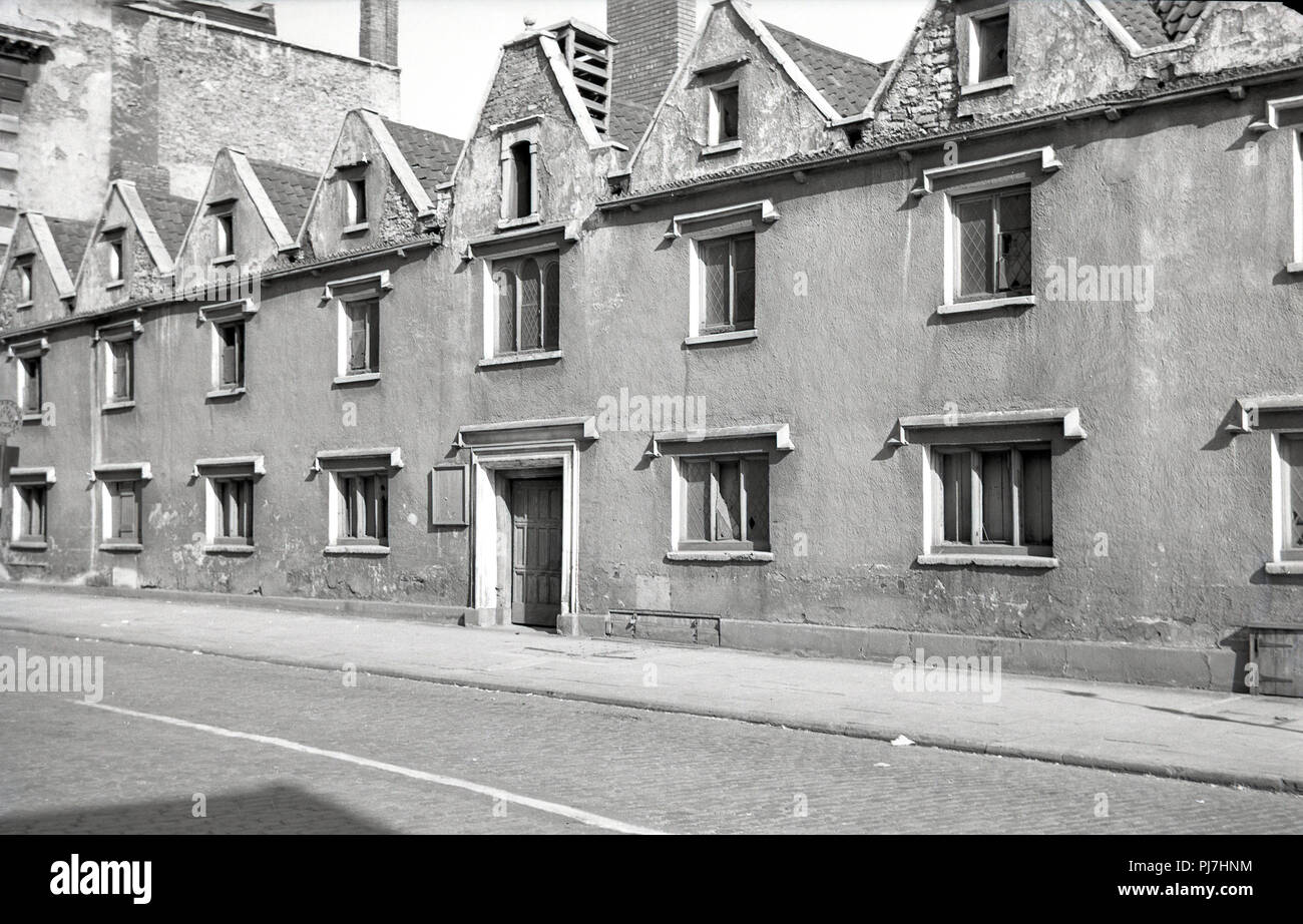 1950, histrocial, post-ww2 Britian, a terrace of old abandonded houses ...