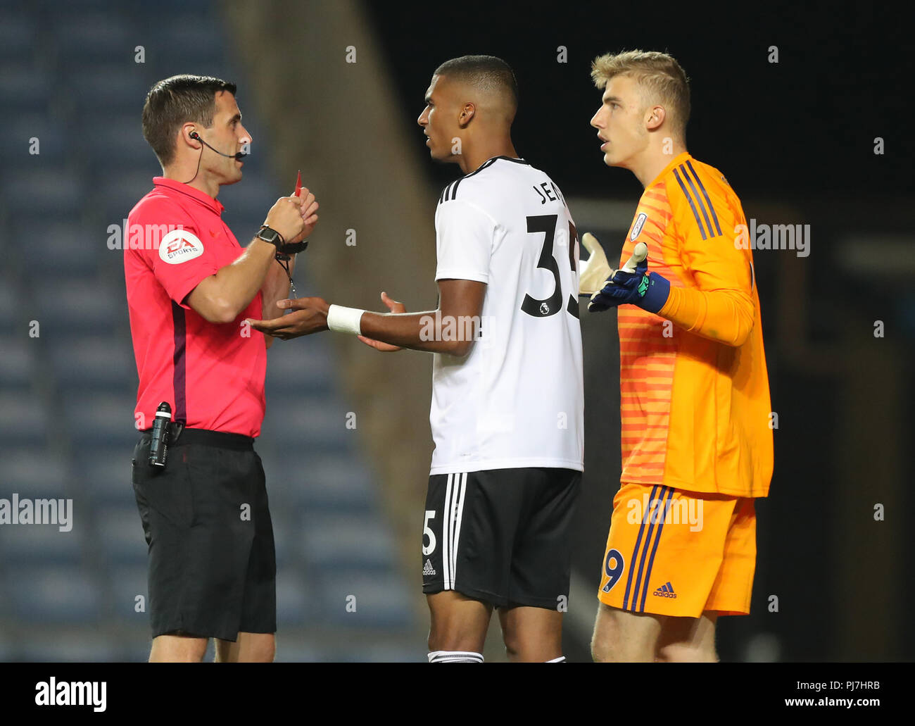 Fulham goalkeeper Toni Stahl (right) protests with referee Craig Hicks ...