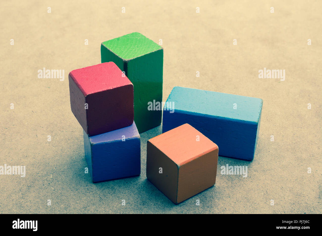 Colorful building blocks on a brown background Stock Photo - Alamy
