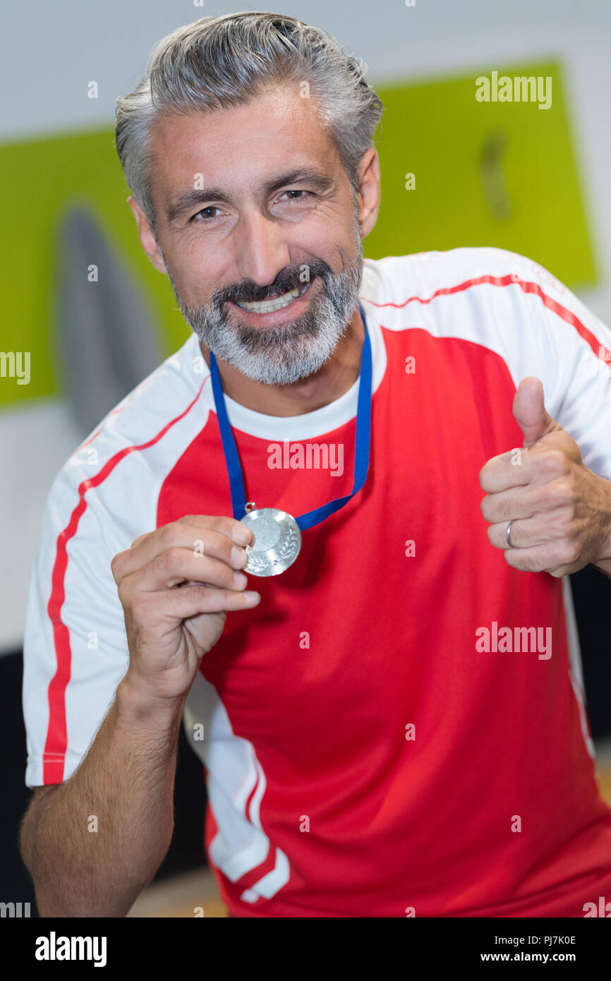 athlete standing with gold medal Stock Photo - Alamy