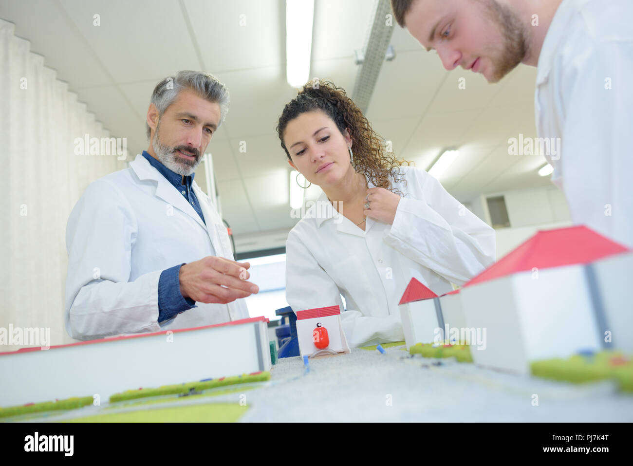 architecture students and teacher near scale model homes Stock Photo ...