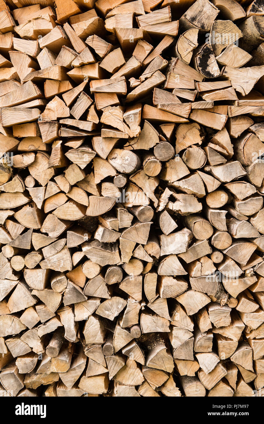 Background of stacked, dry chopped logs used for firewood Stock Photo ...