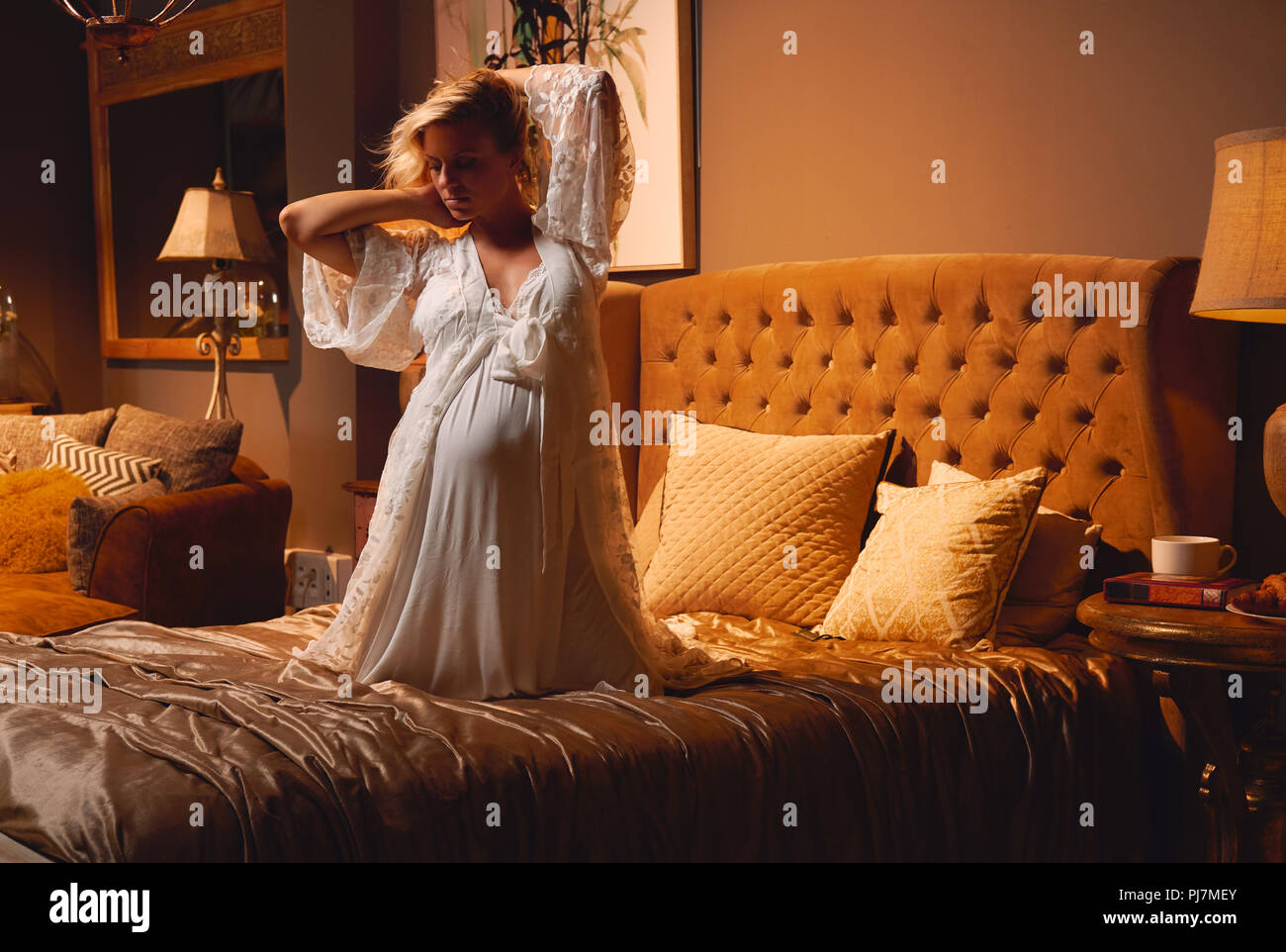 Young Relaxed Attractive Blond Pregnant Woman Wearing White Rest Gown