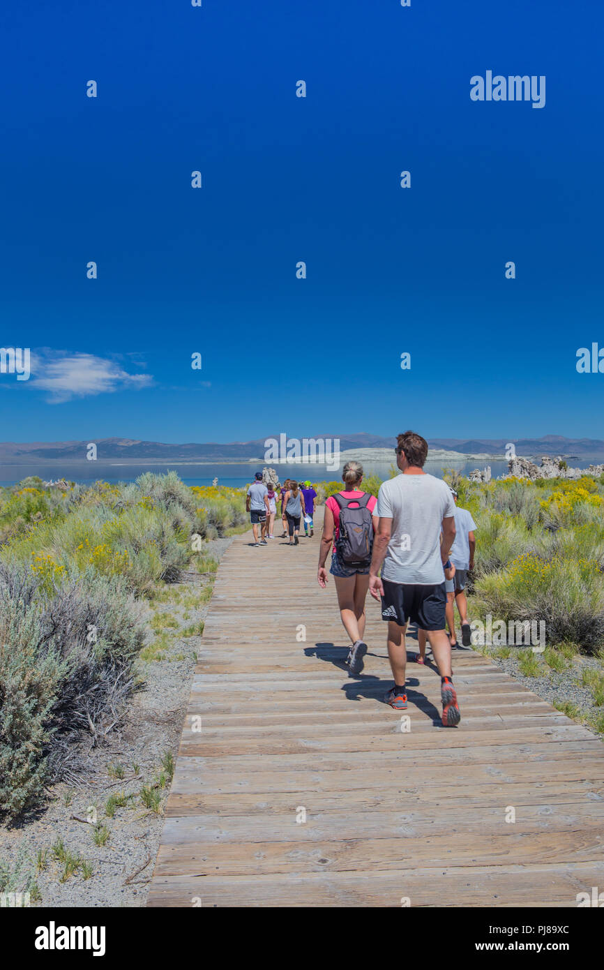 Visitors arriving at Mono Lake walk along the boardwalk to view theTufa ...