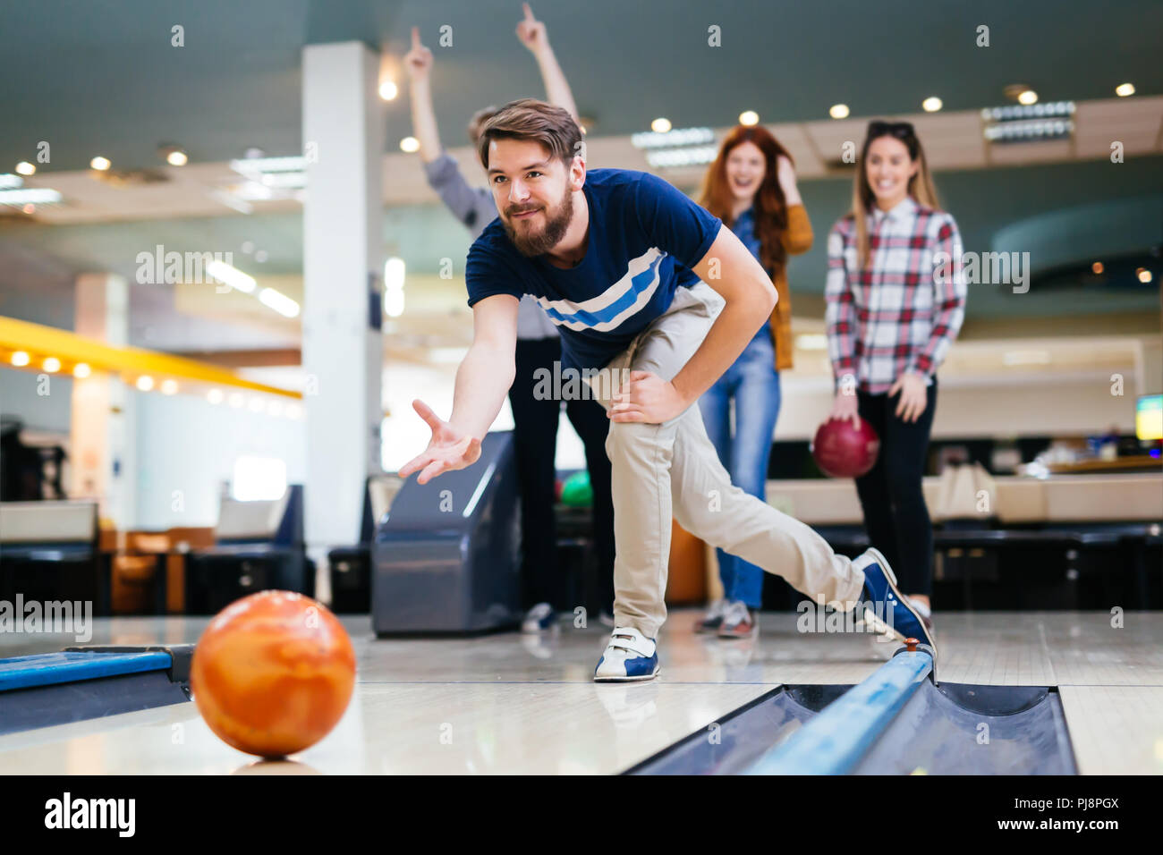 Friends bowling at club Stock Photo - Alamy