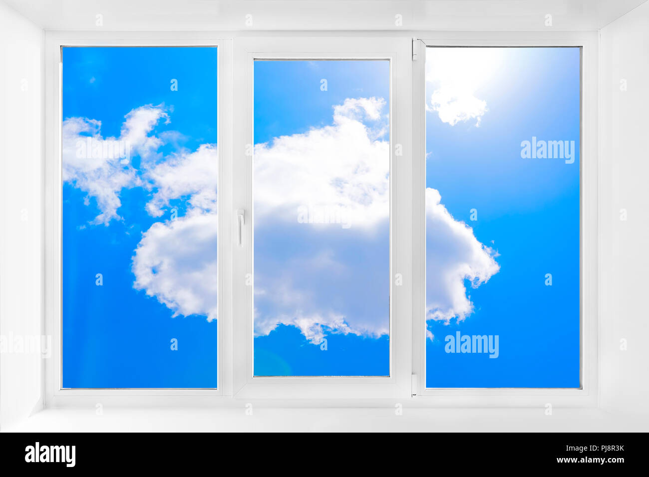 Clean window with an empty sill and blue sky. White plastic three ...