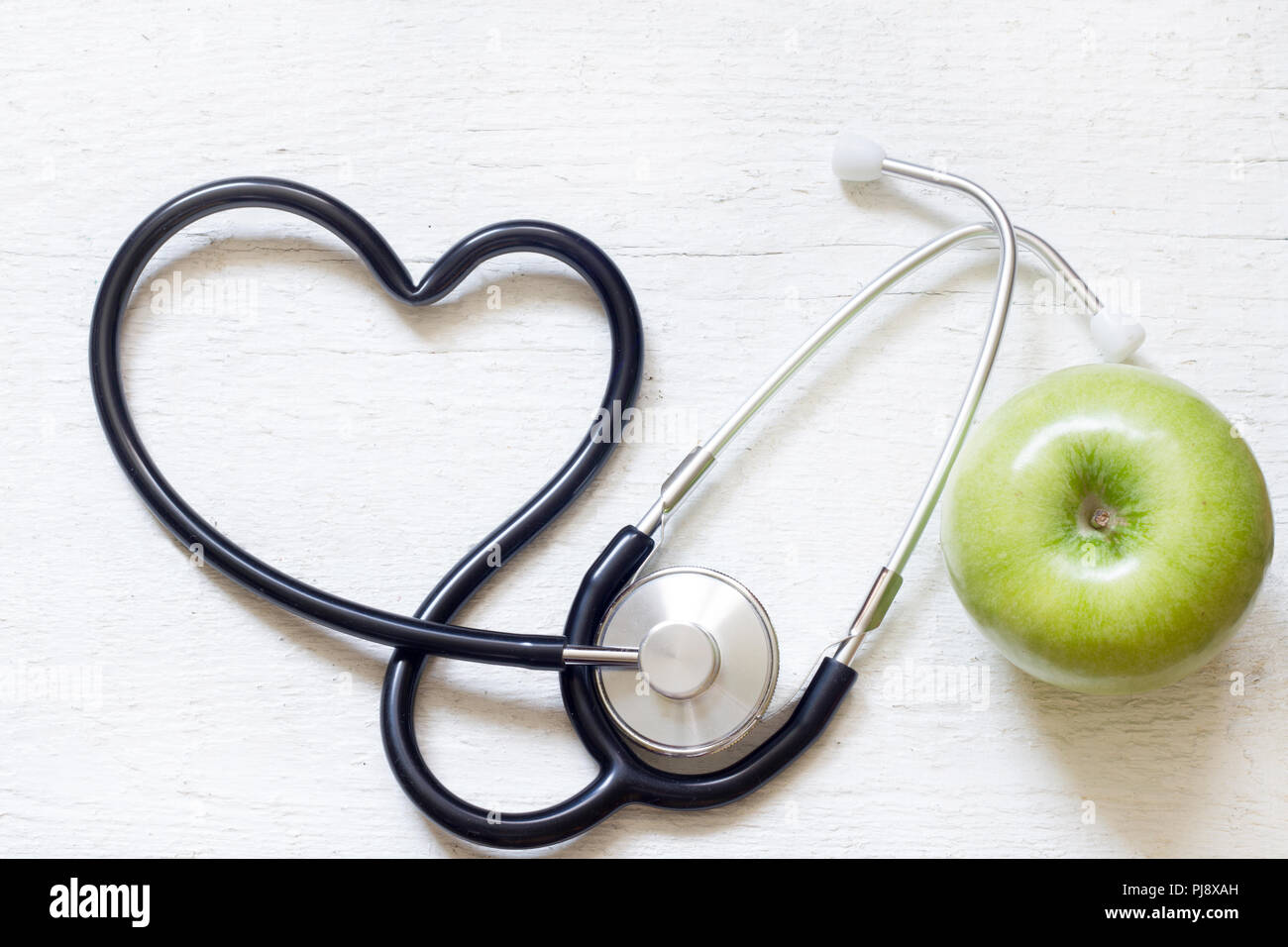 Healthy heart alternative medicine concept with stethoscope on white ...