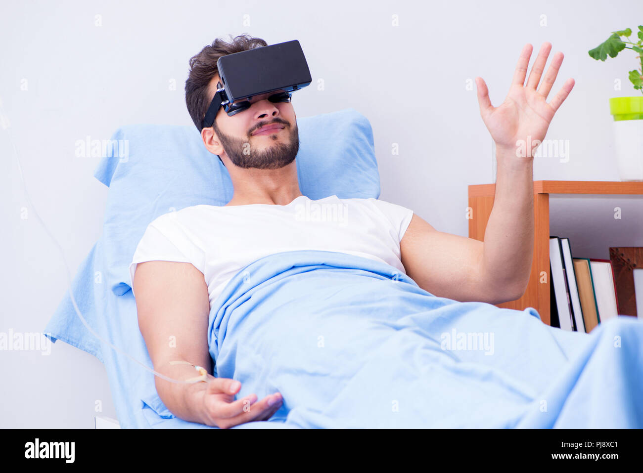 Patient in the hospital with VR glasses headset Stock Photo - Alamy