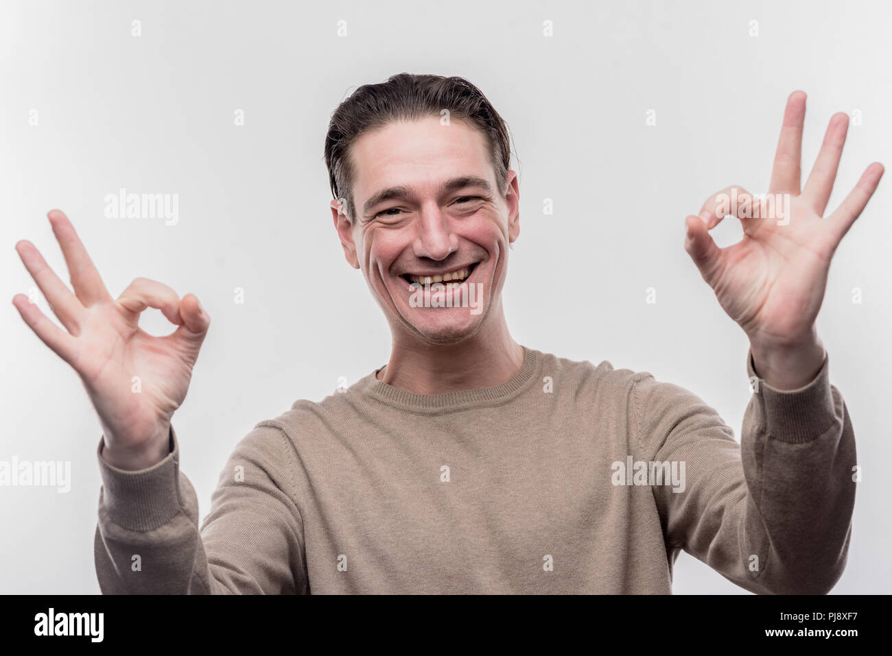 Beaming dark-haired man feeling extremely emotional and satisfied Stock ...