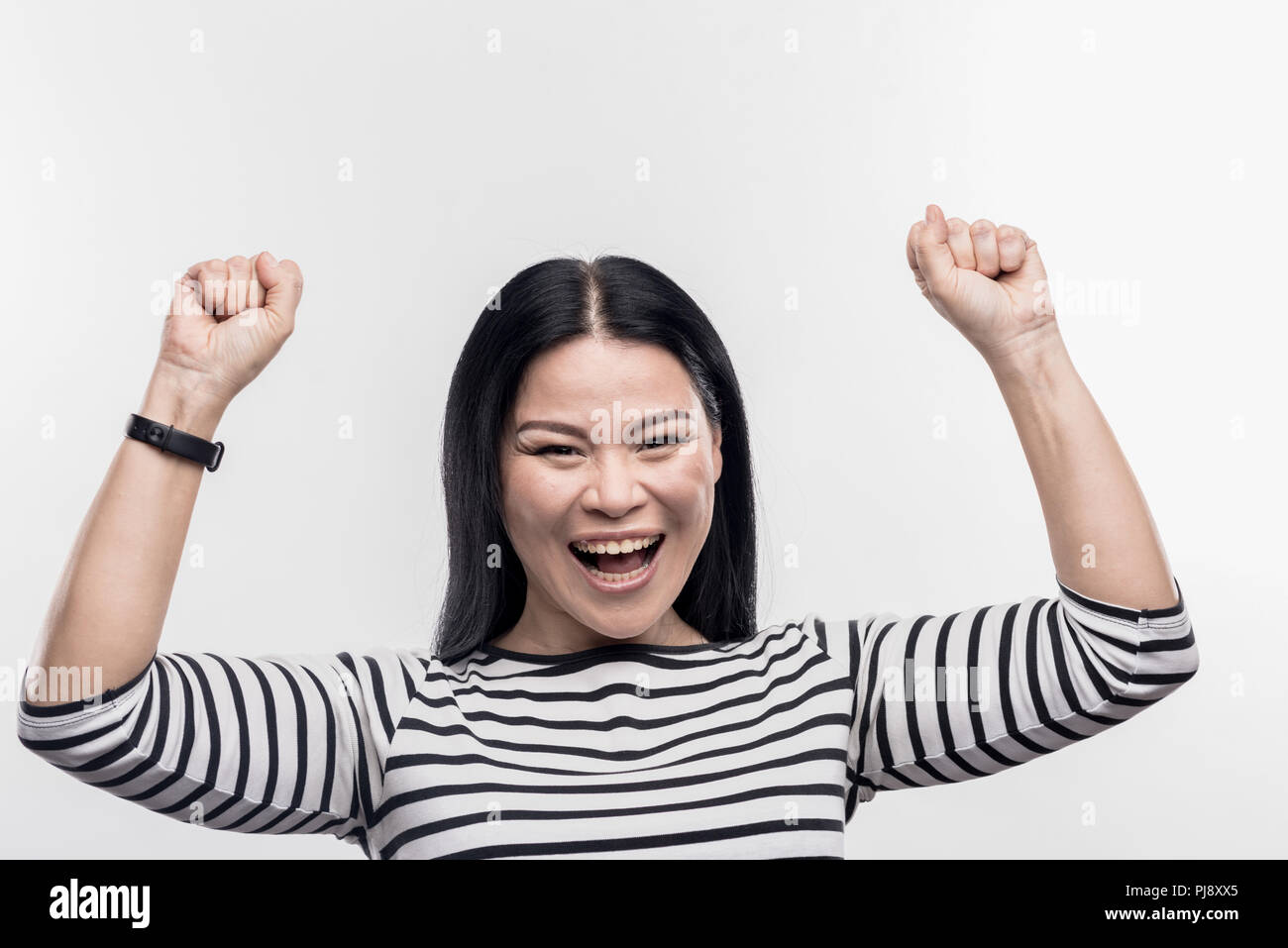 Beaming dark-haired manager feeling extremely happy after getting ...