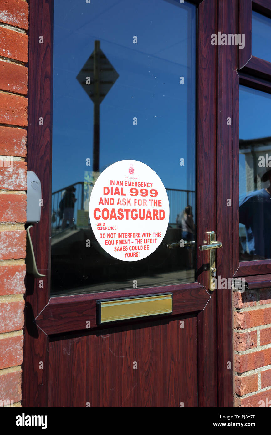 Information on a sign in the door window of HM Coastguard Office ...