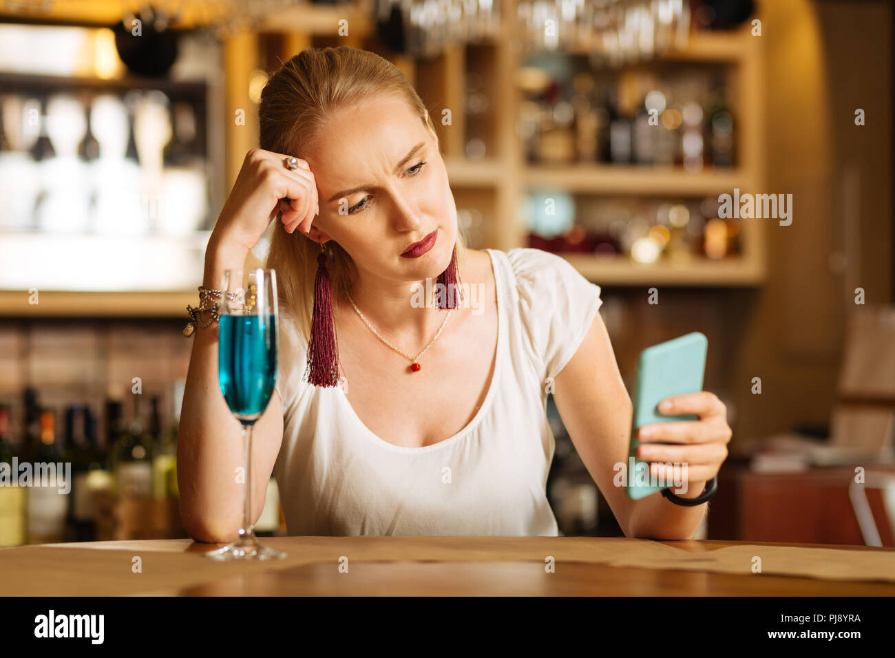 Drunk bar visitor checking smartphone hi-res stock photography and ...
