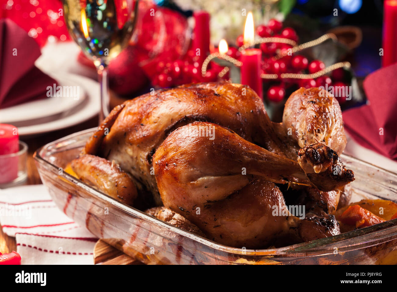 Baked or roasted whole chicken on Christmas table. Xmas dinner Stock ...