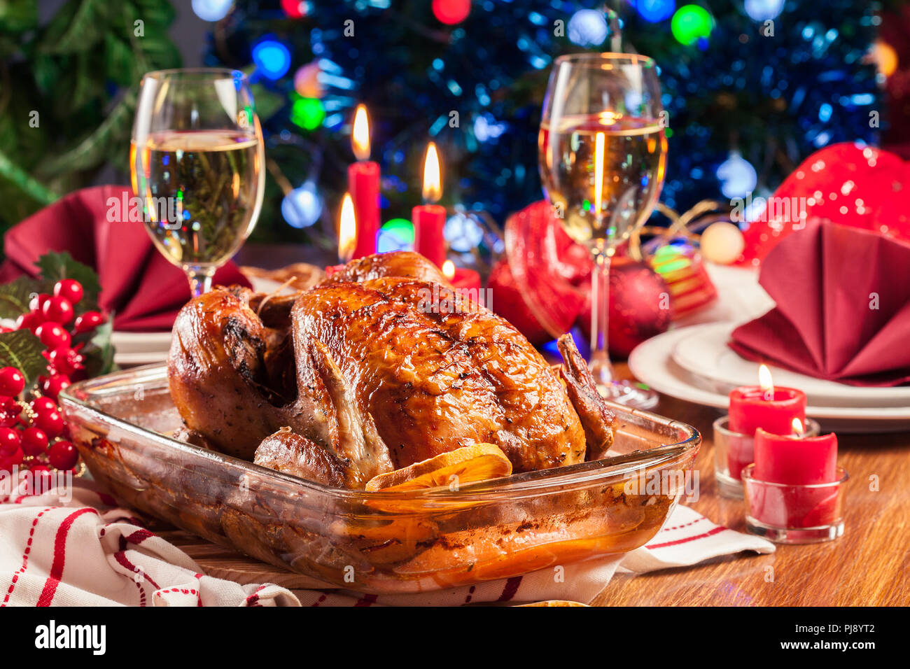 Baked or roasted whole chicken on Christmas table. Xmas dinner Stock ...