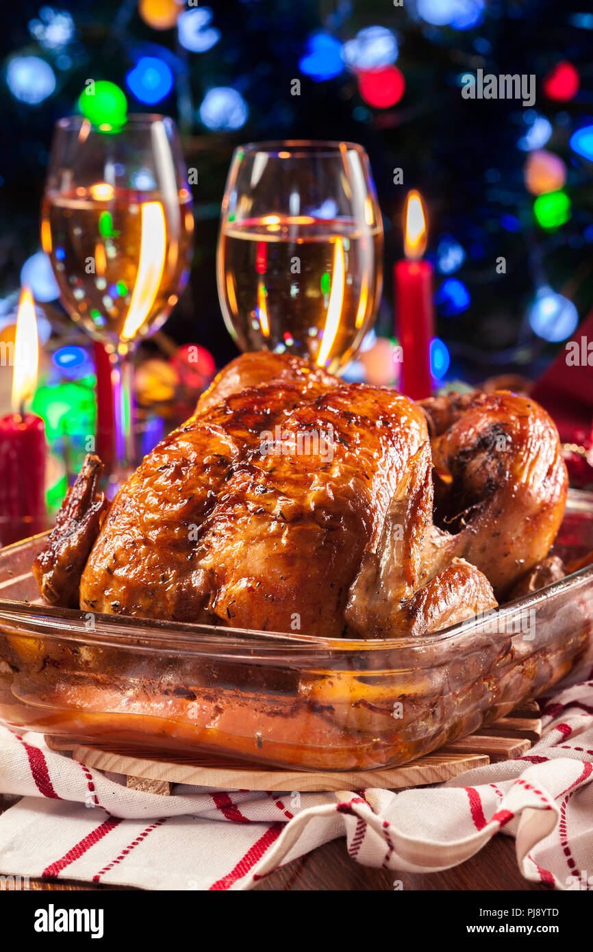 Baked or roasted whole chicken on Christmas table. Xmas dinner Stock ...