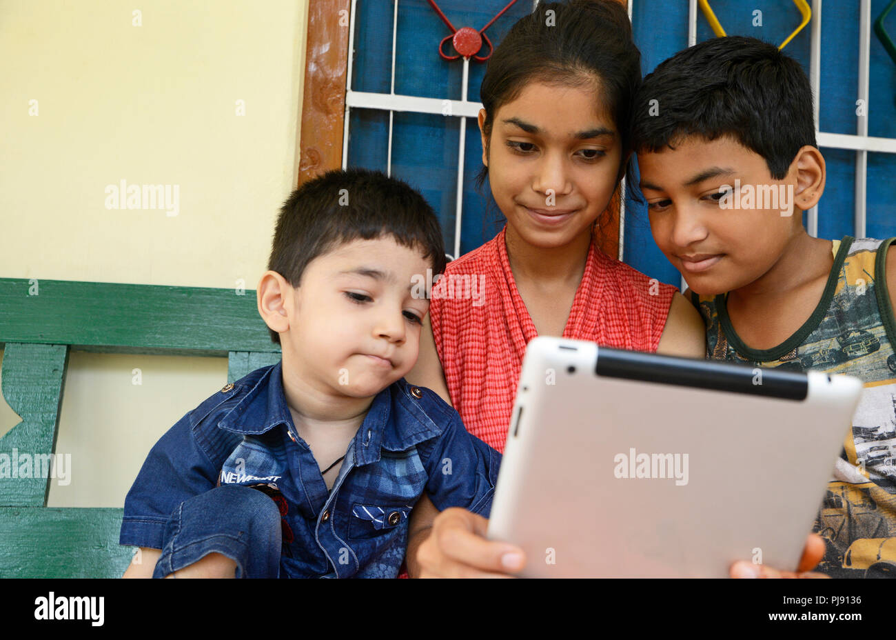Indian children using Tab Stock Photo - Alamy