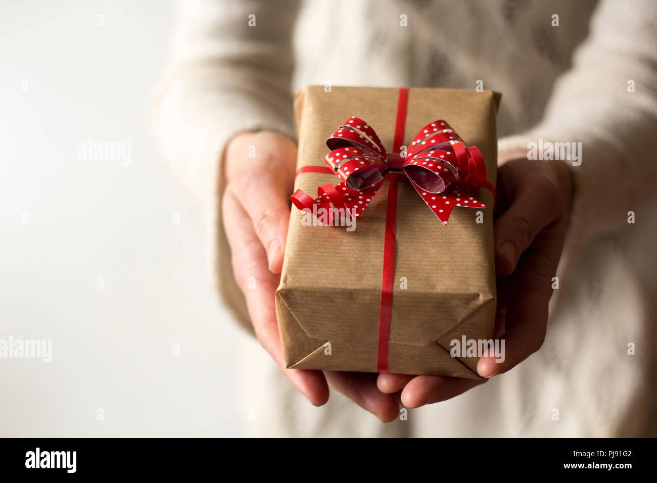 Hands giving and receiving a present hi-res stock photography and images - Alamy