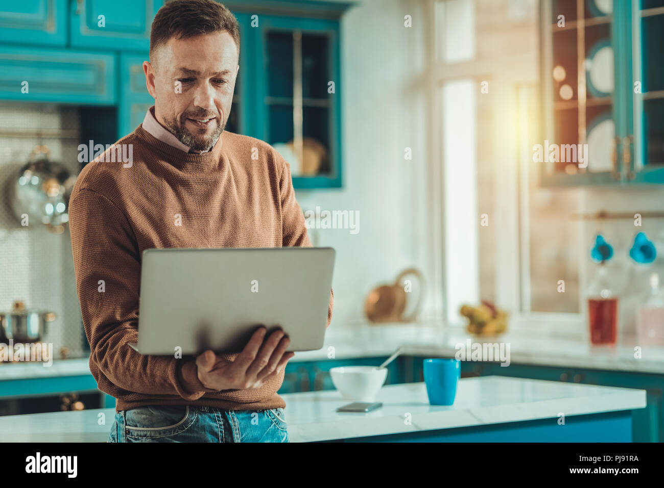Serious confident man looking at the screen Stock Photo - Alamy