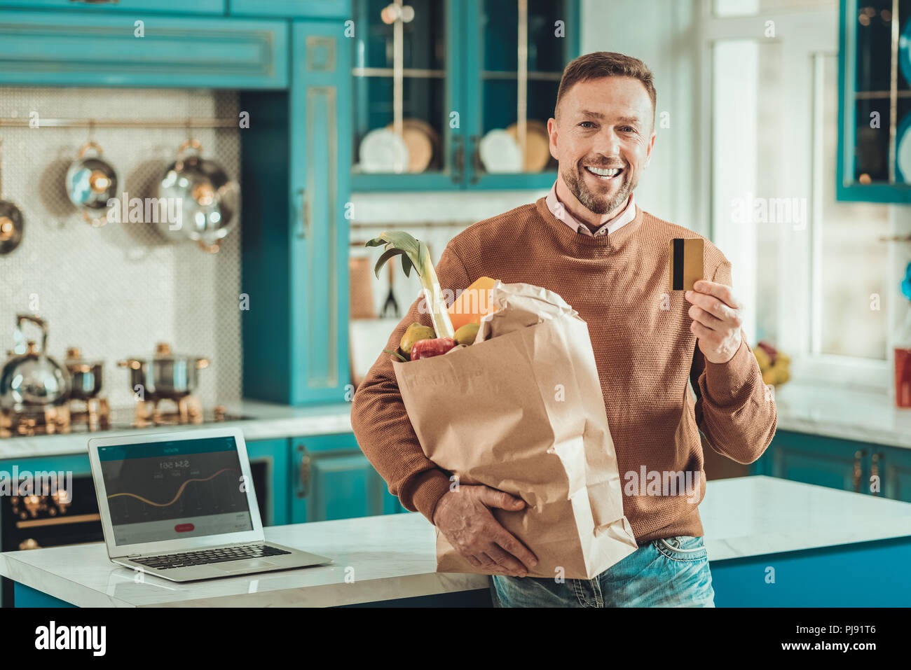 Smiling man coming back from a supermarket Stock Photo - Alamy