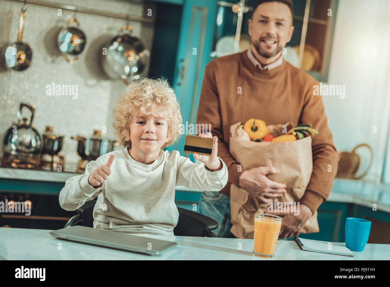 Little child holding a credit card in a hand Stock Photo - Alamy