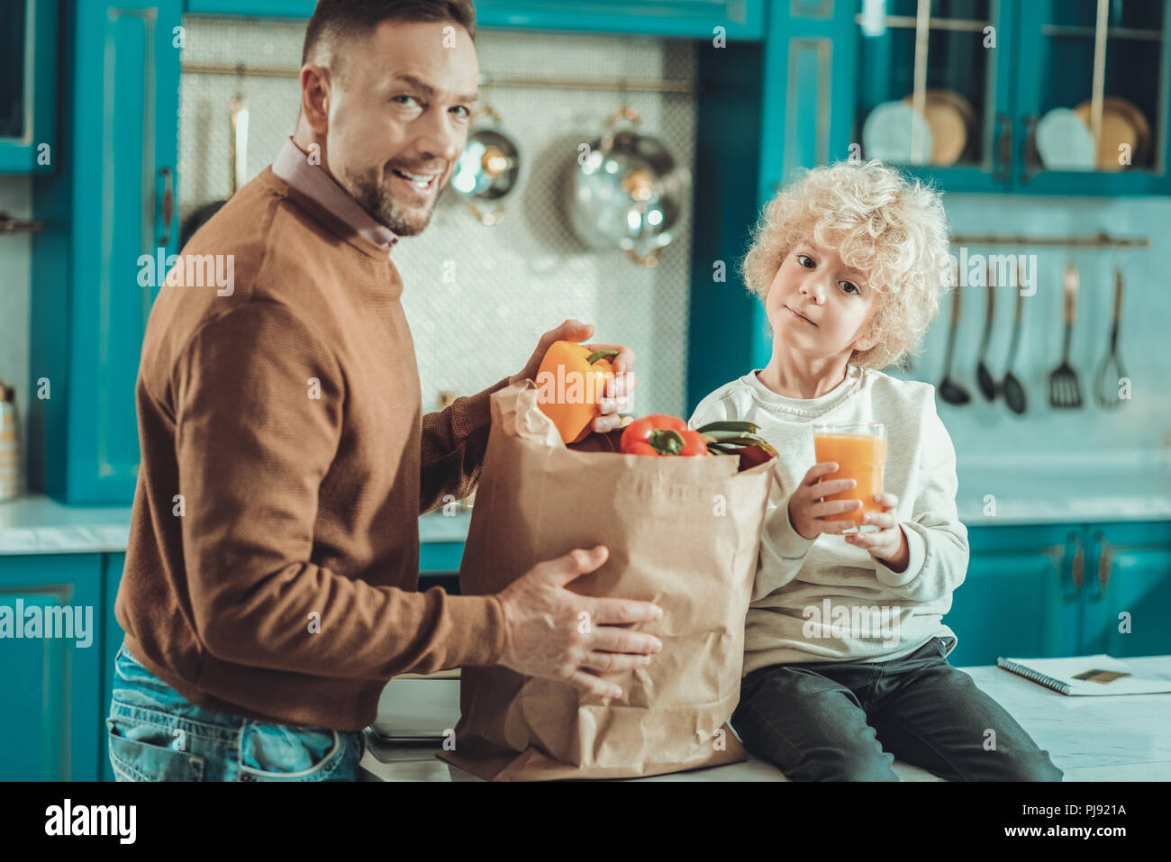 Son and dad cooking lunch in the kitchen Stock Photo - Alamy