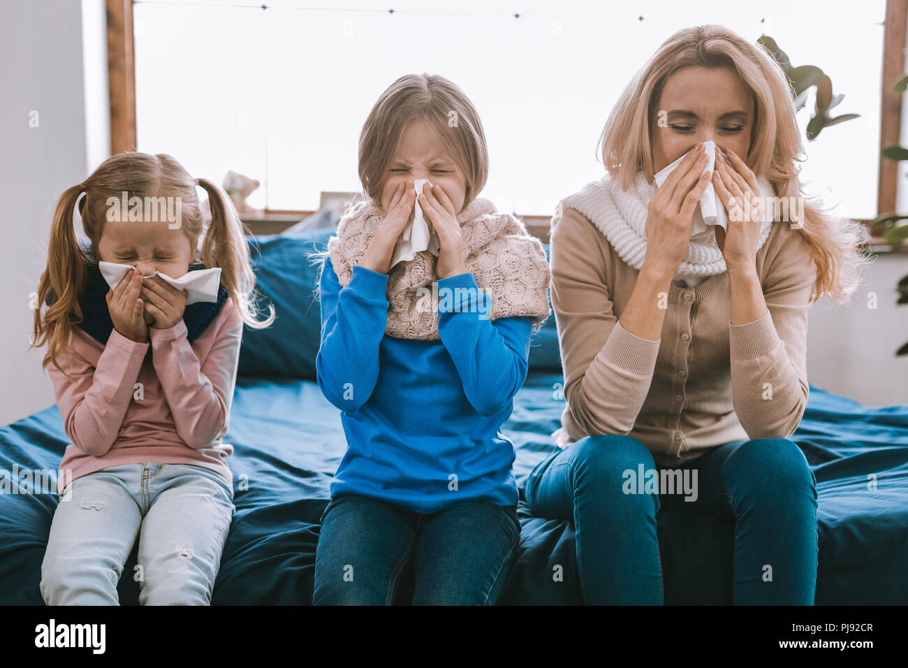 Unhappy cheerless family sneezing Stock Photo - Alamy