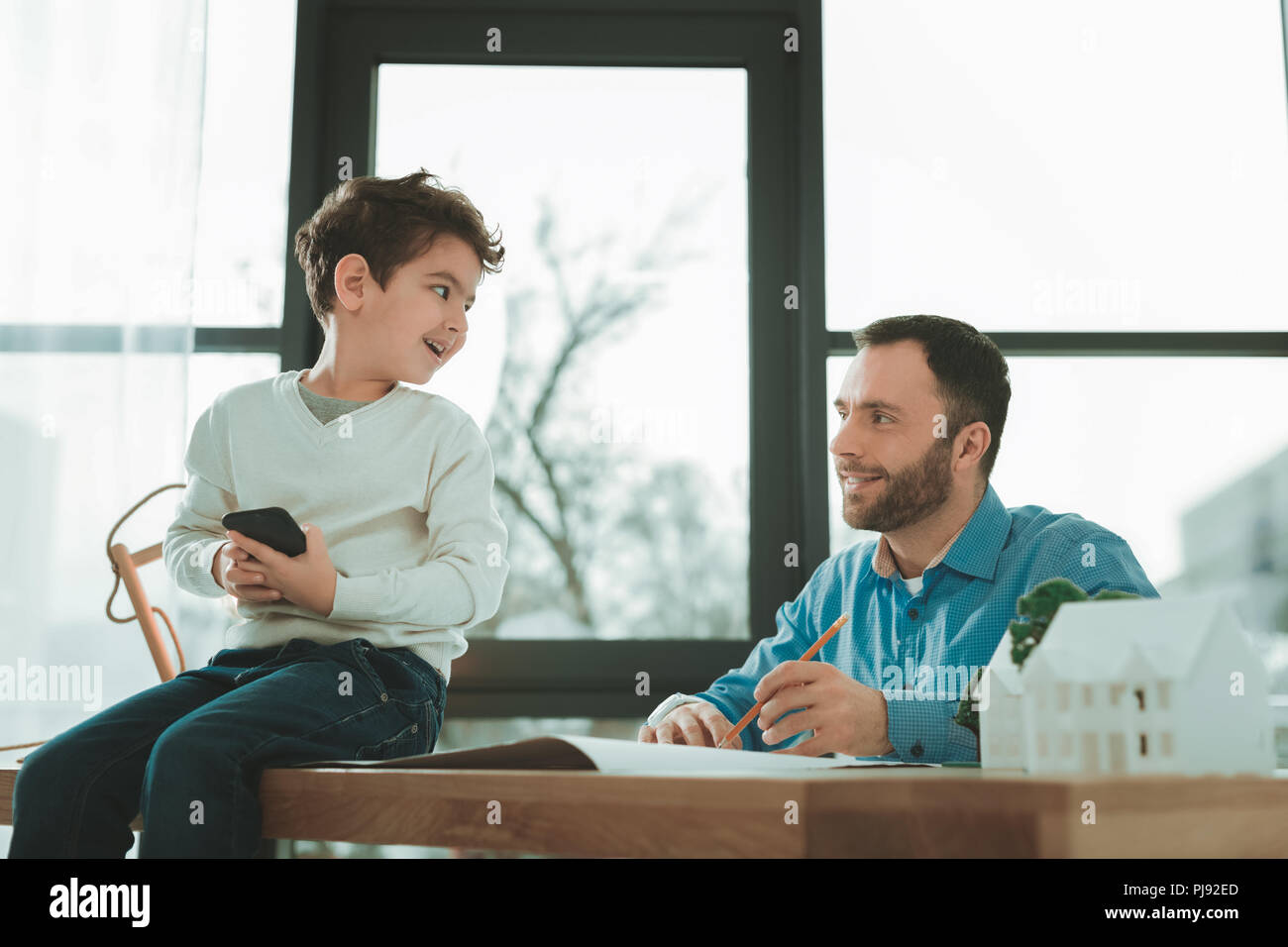 Happy cute boy looking at his father Stock Photo - Alamy