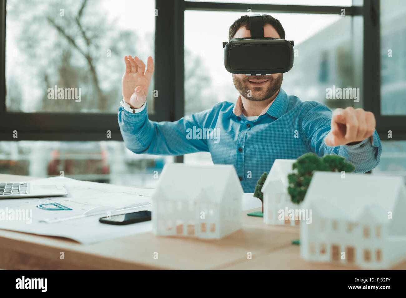 Joyful positive man pointing at the house Stock Photo - Alamy