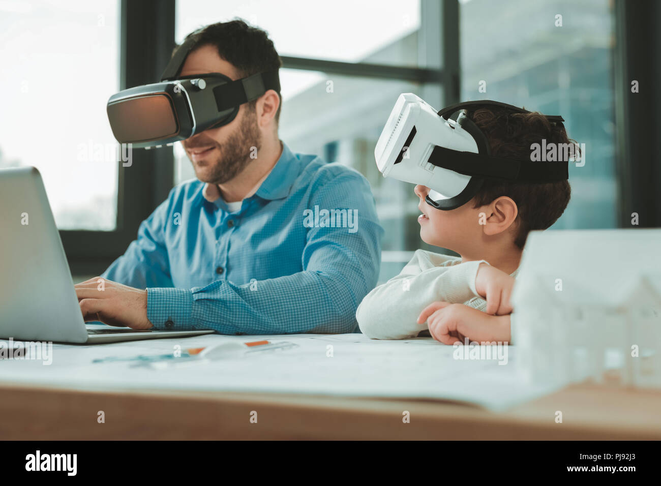 Pleasant cute boy looking at his father Stock Photo - Alamy