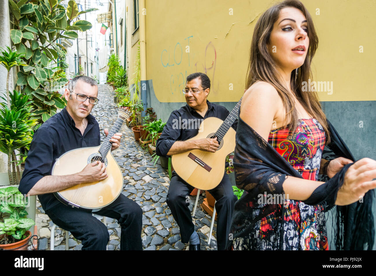 Fado band performing traditional portuguese music on the narrow street ...