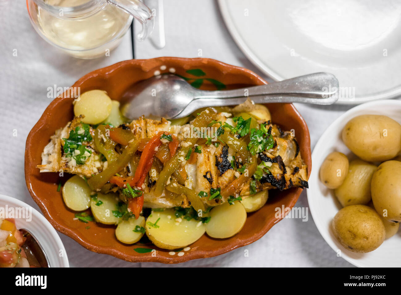 Traditional portuguese golden fish with red and green pepper served ...