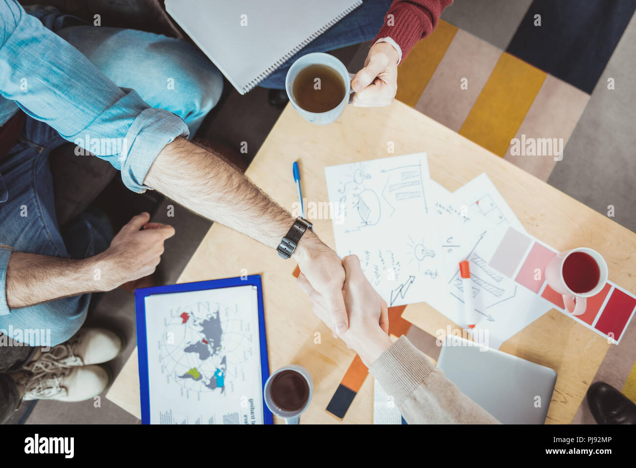 Young man shaking hands Stock Photo - Alamy