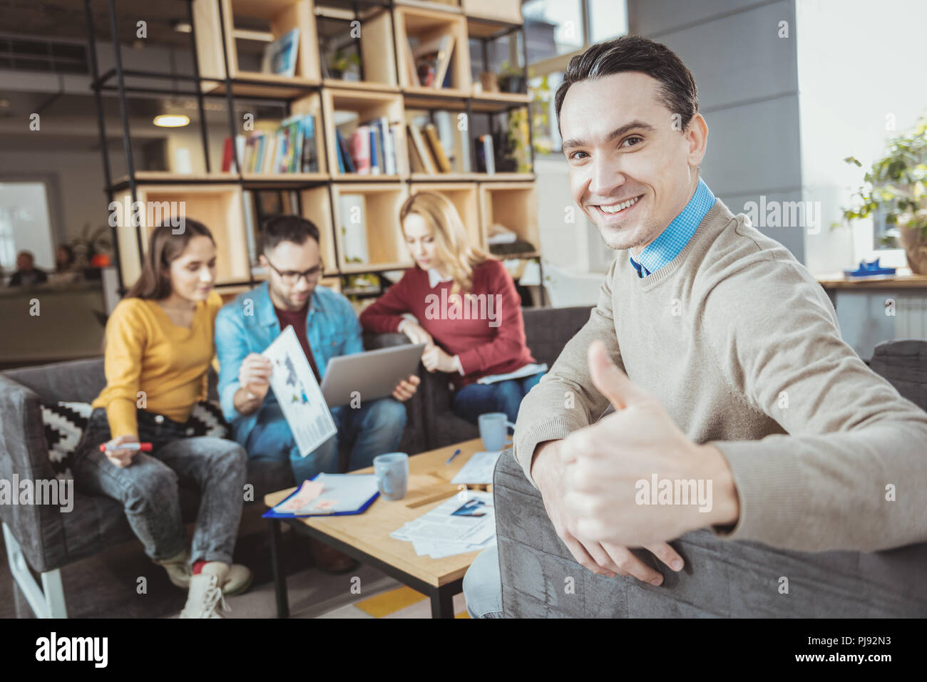 Ambitious male colleague collecting team Stock Photo - Alamy