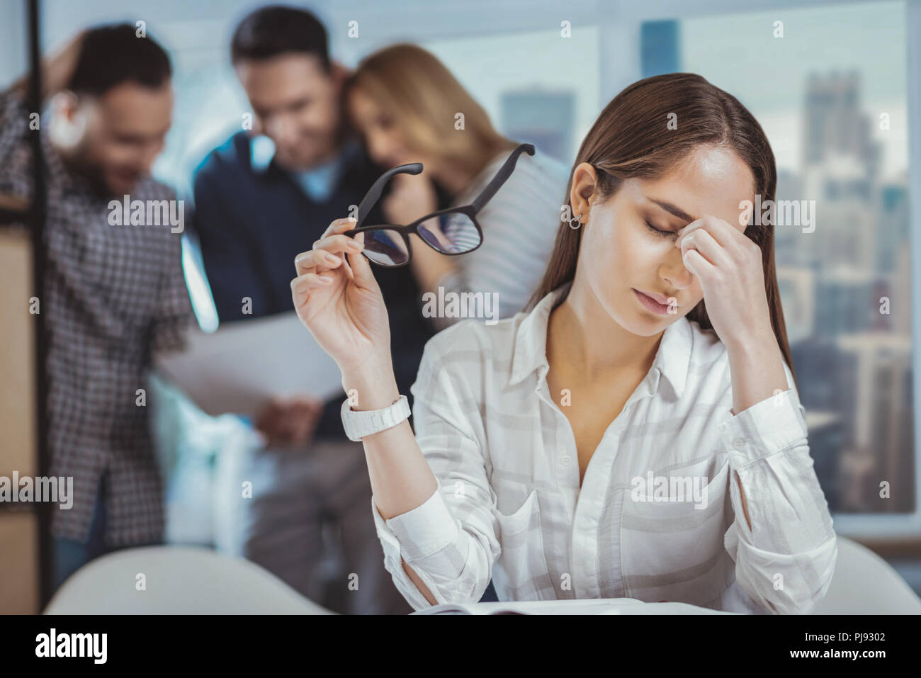 Tired female colleague finishing work Stock Photo - Alamy