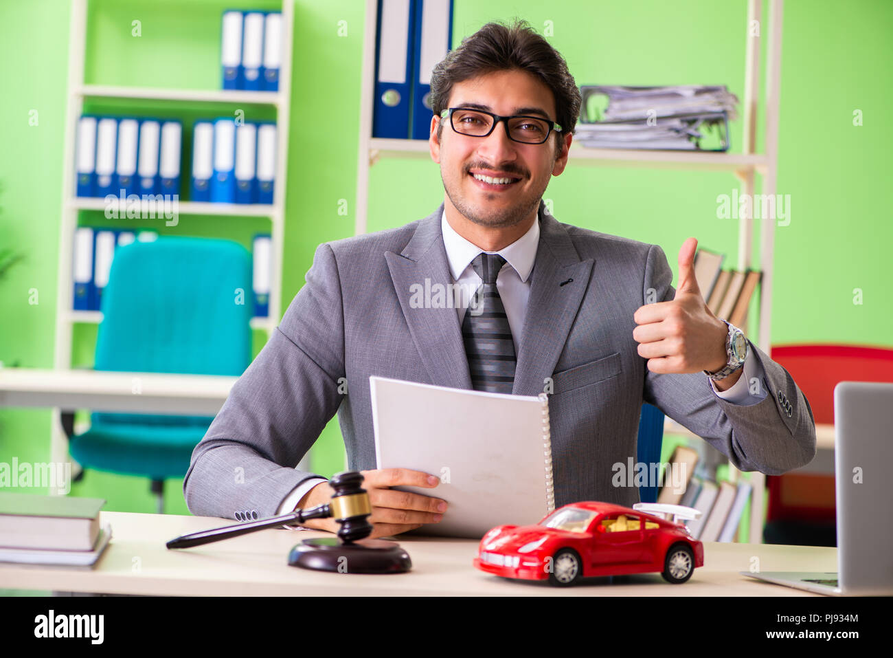 Young handsome lawyer working in the office Stock Photo - Alamy
