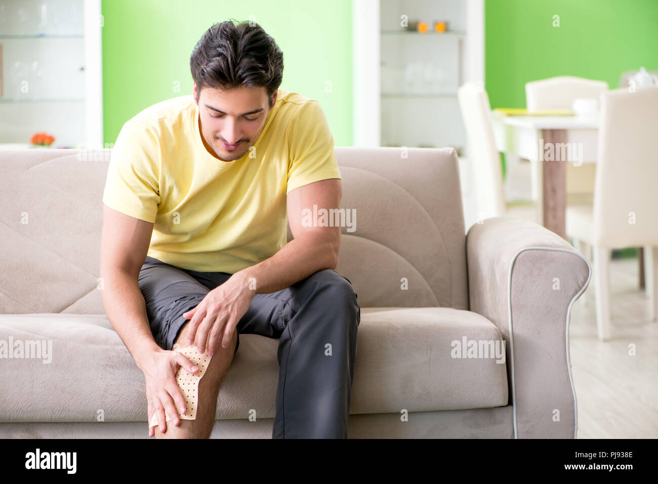 Man applying pepper Capsicum plaster to relieve pain Stock Photo - Alamy