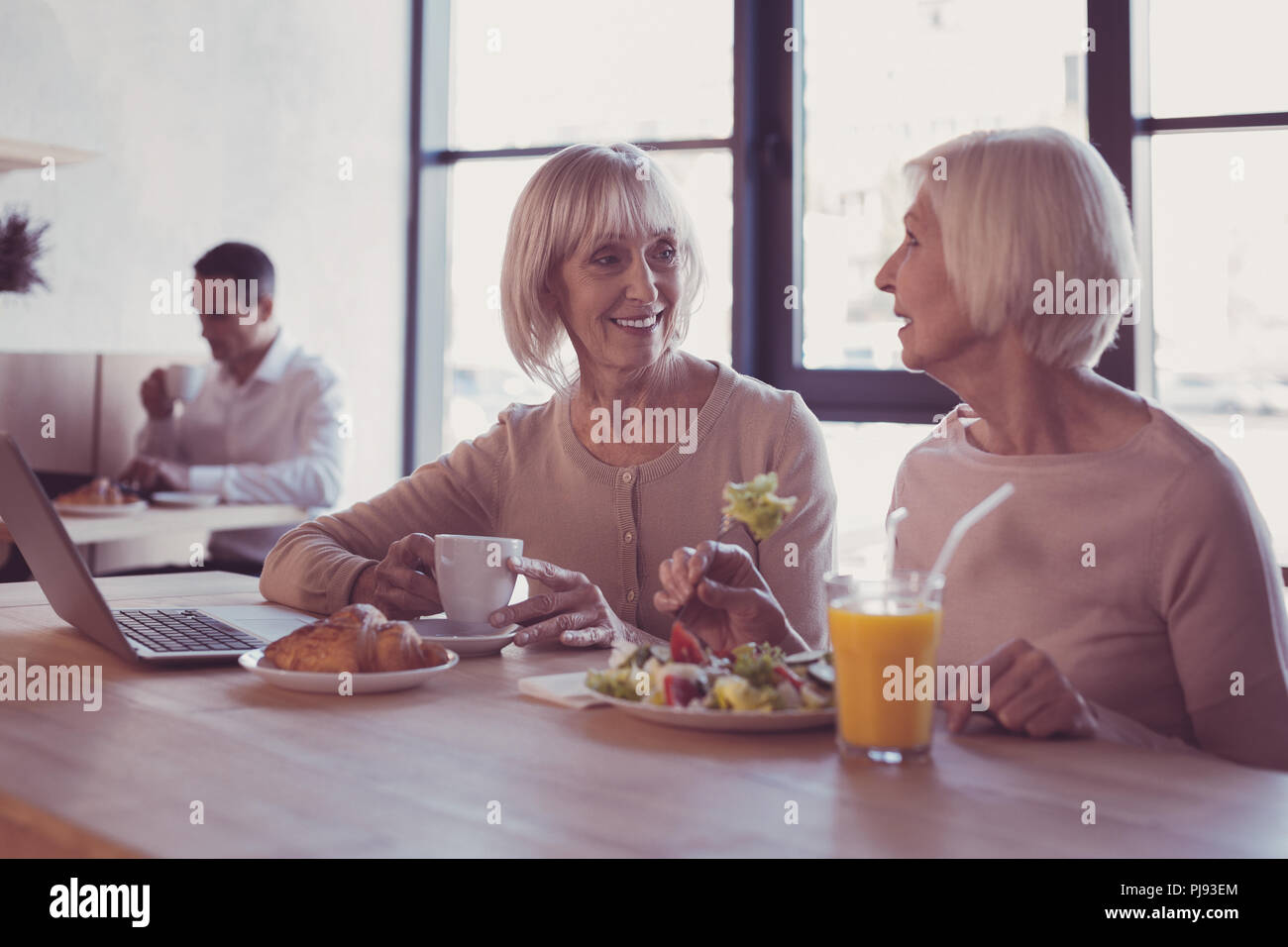 Interested attentive woman sitting and listening to her girlfriend ...