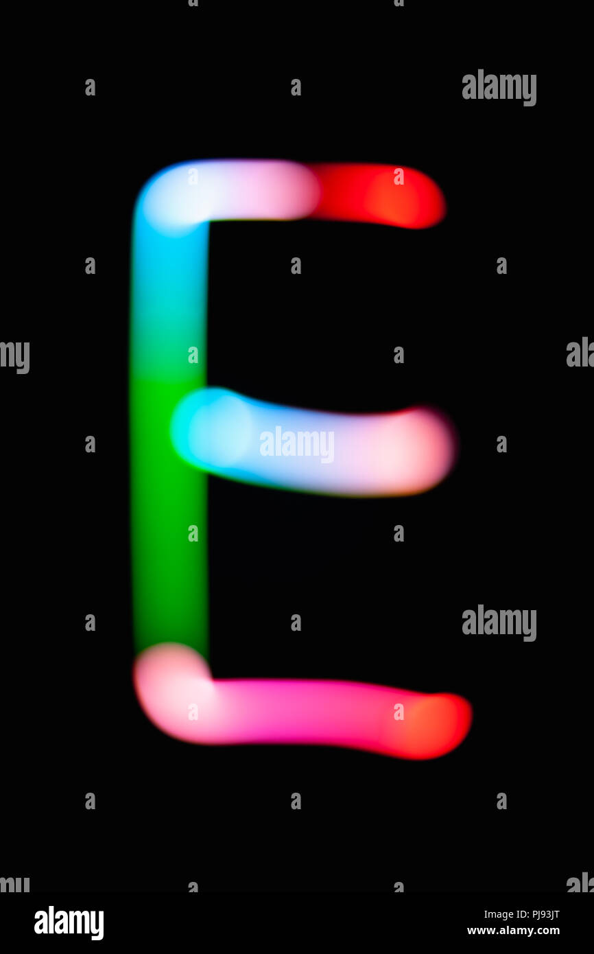 Letter E. Glowing letters on dark background. Abstract light painting ...