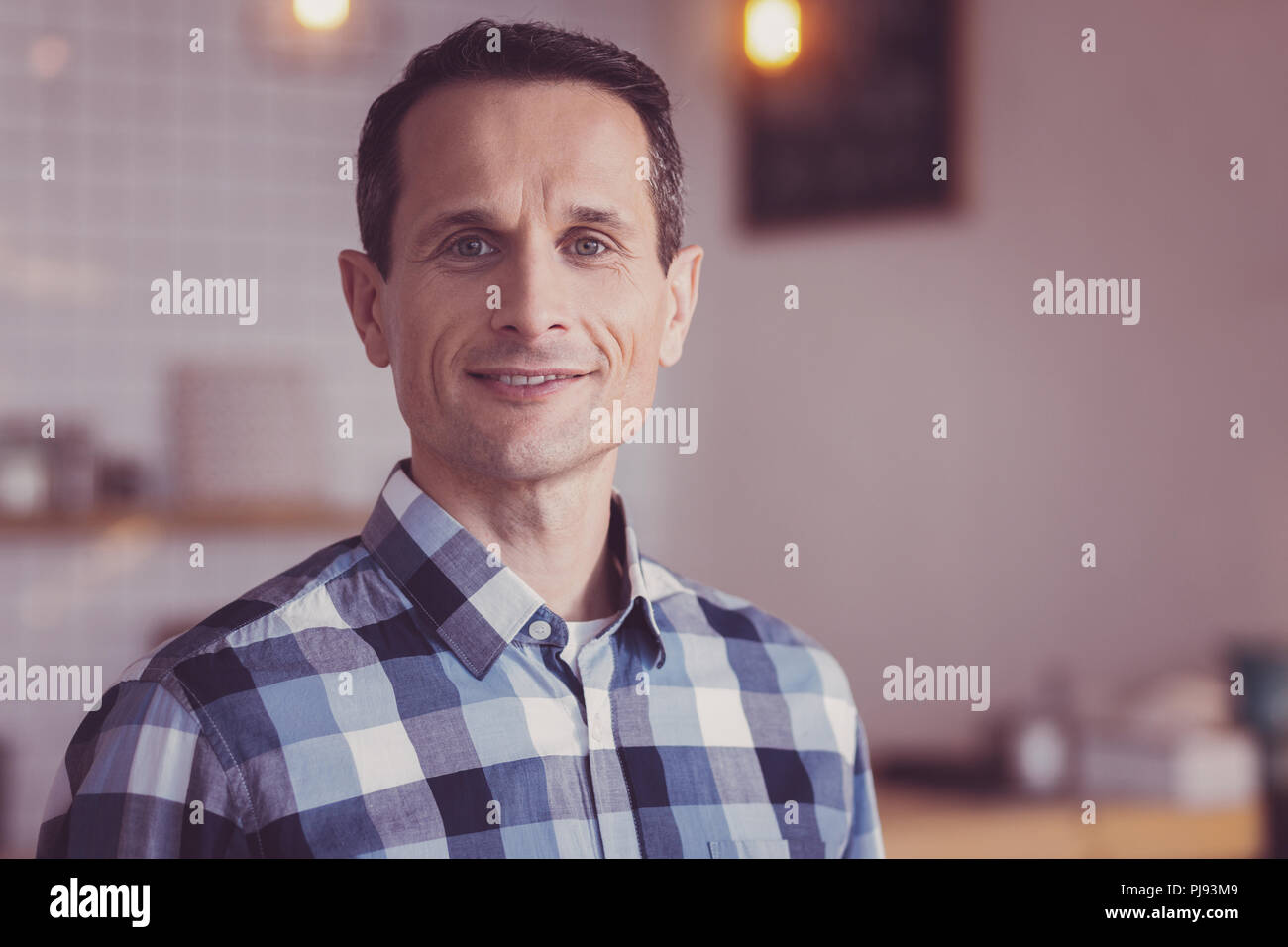 Confident handsome man smiling and looking straight Stock Photo - Alamy