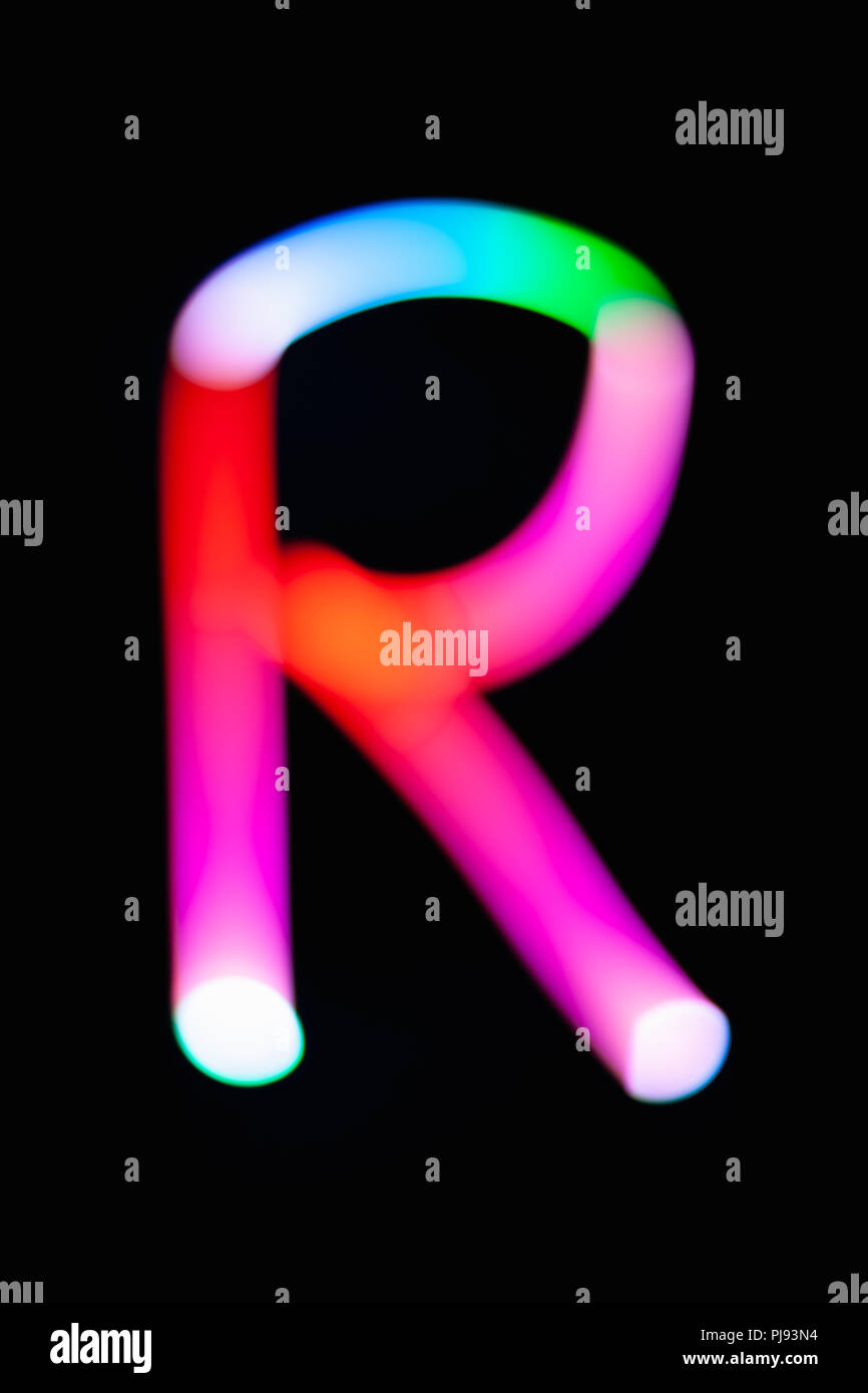Letter R. Glowing letters on dark background. Abstract light painting ...