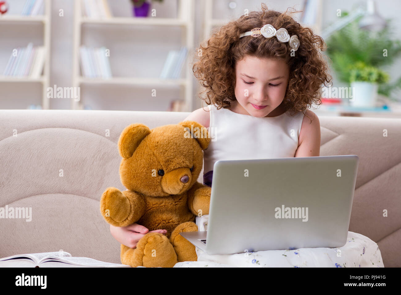 Little girl surfing internet on laptop Stock Photo - Alamy