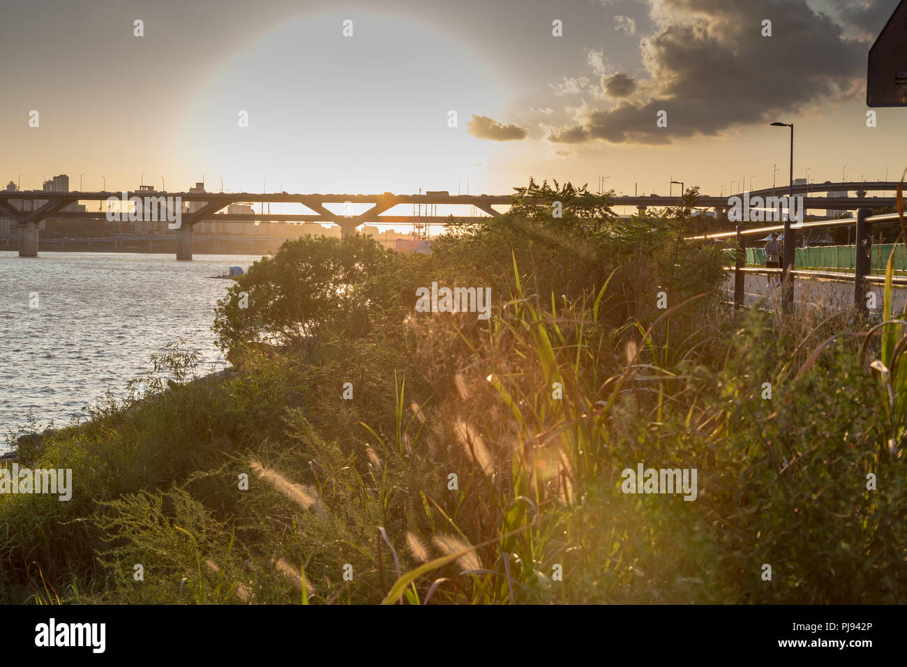 Impressive sunset over the Han river with bridge at the riverside park ...