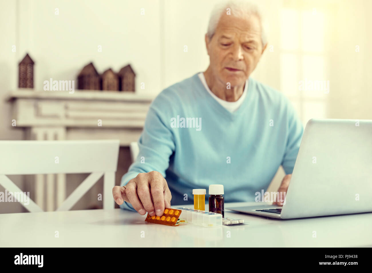 Elderly man reaching for his medication Stock Photo - Alamy